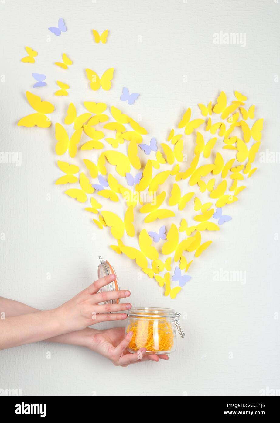 Paper yellow butterfly in form of heart fly out bank Stock Photo - Alamy