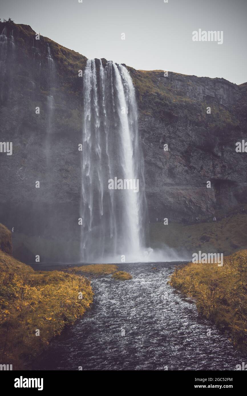Vertical shot of the Seljalandsfoss waterfall on a gloomy day in ...