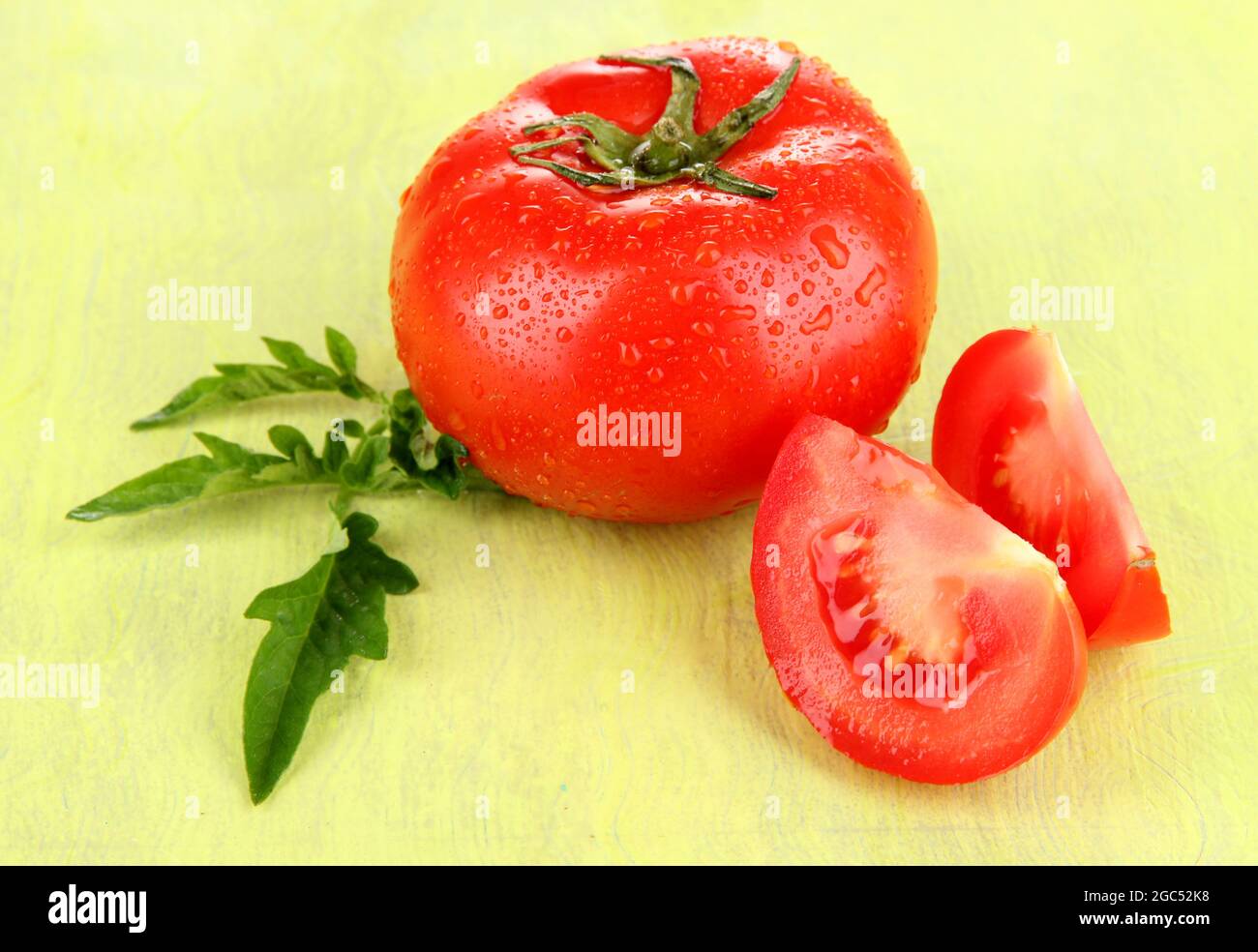 Fresh tomato on colour wooden background Stock Photo - Alamy