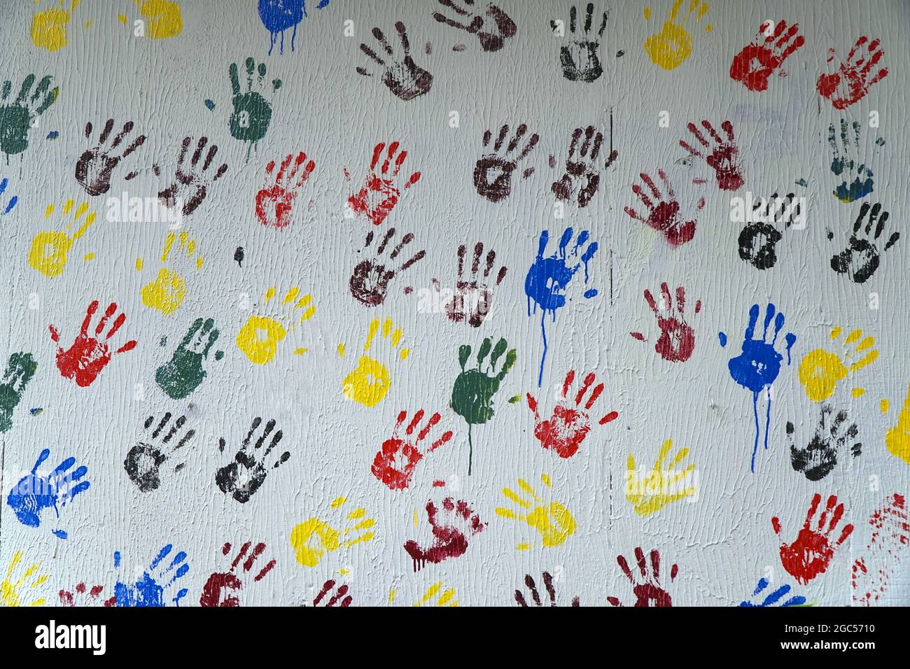 Colorful hand marks on a white wall Stock Photo - Alamy