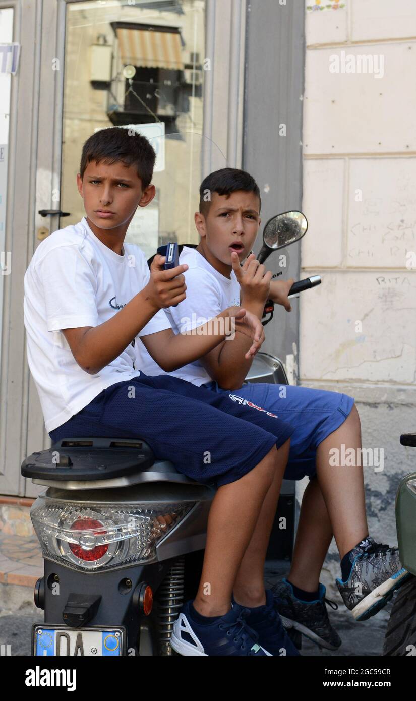 Stylish Italian teenagers sitting on a scooter in Naples, Italy Stock ...