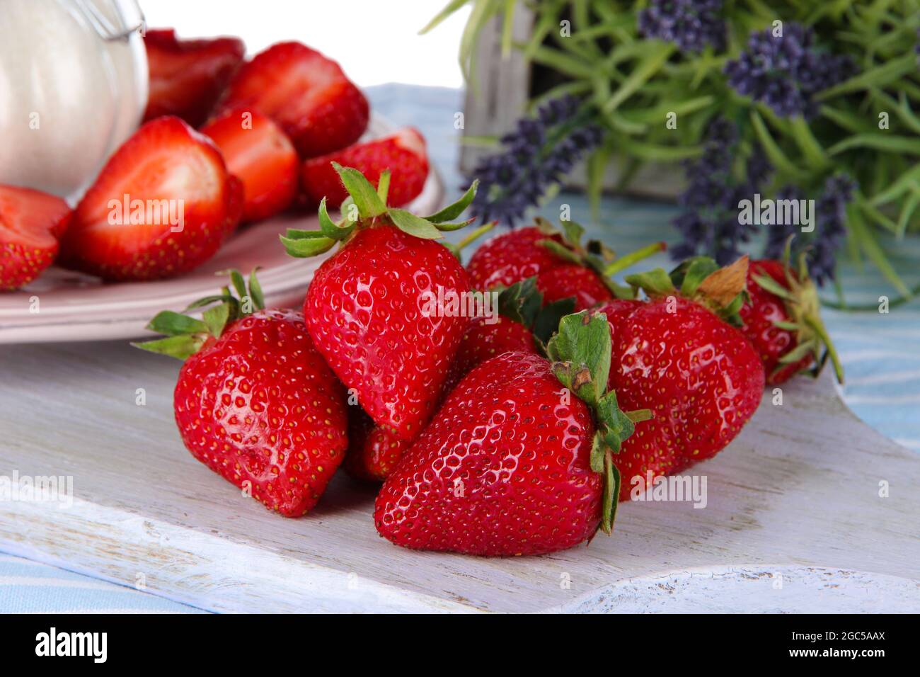 Strawberries on board cutting close-up Stock Photo - Alamy