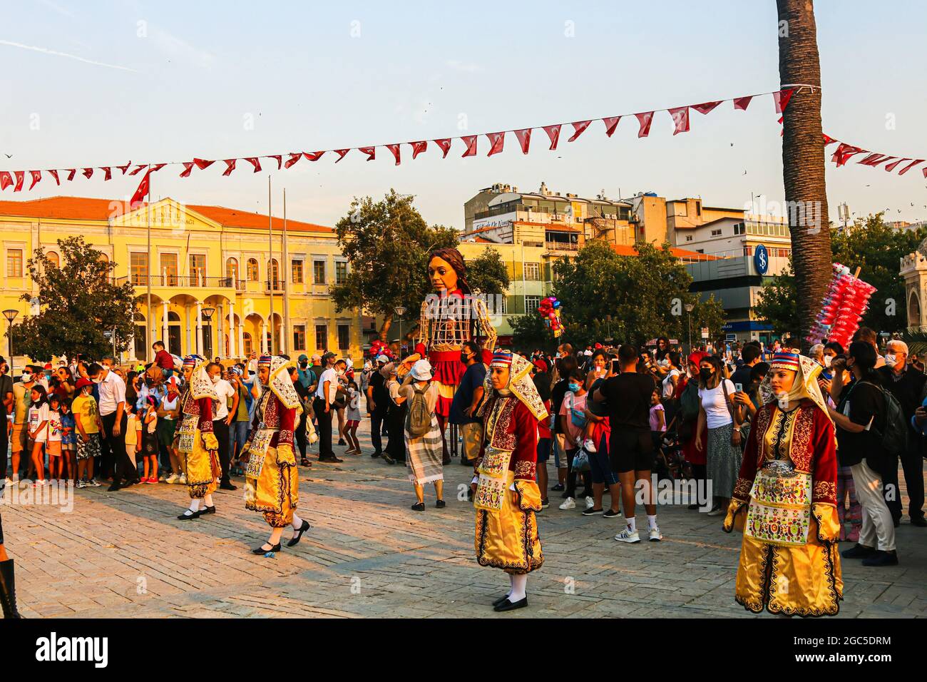 People wearing traditional outfits perform for the giant puppet "Amal ...