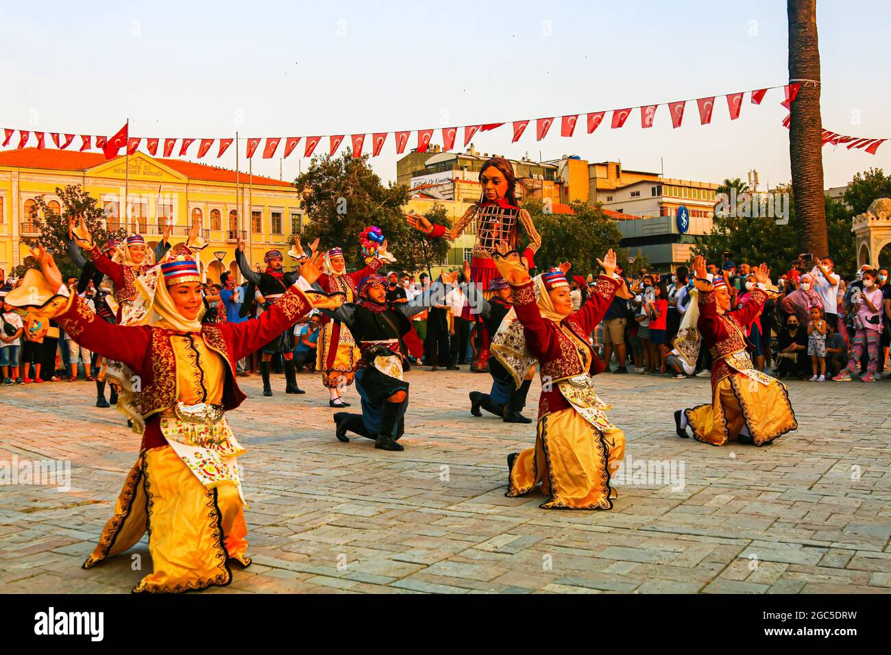 People wearing traditional outfits perform for the giant puppet "Amal ...