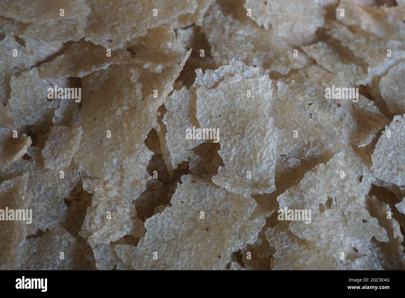 Raw kerupuk gendar (puli, kerupuk beras, Lempeng Puli) with a natural ...