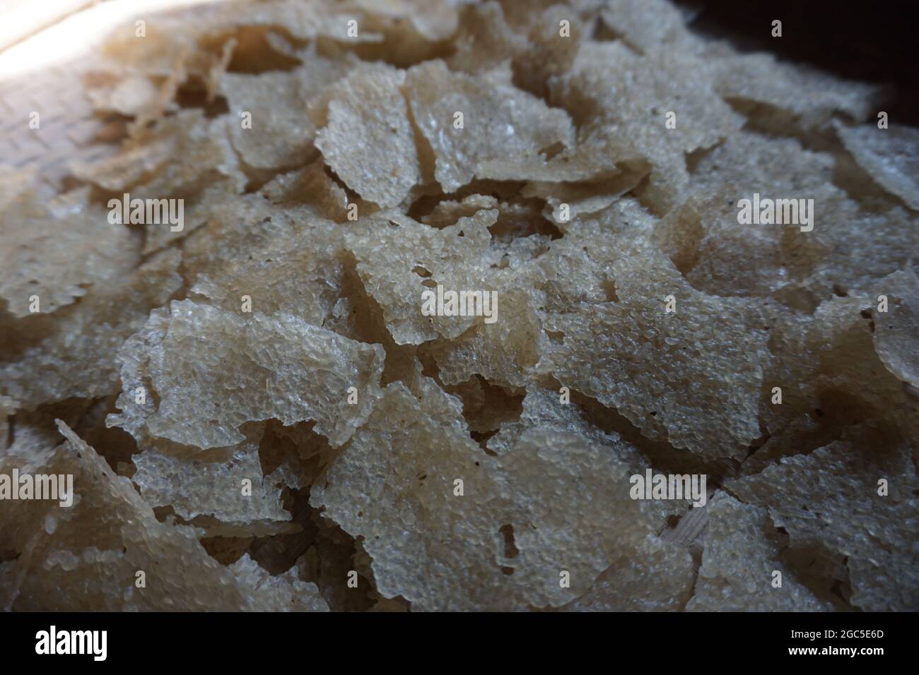 Raw kerupuk gendar (puli, kerupuk beras, Lempeng Puli) with a natural ...