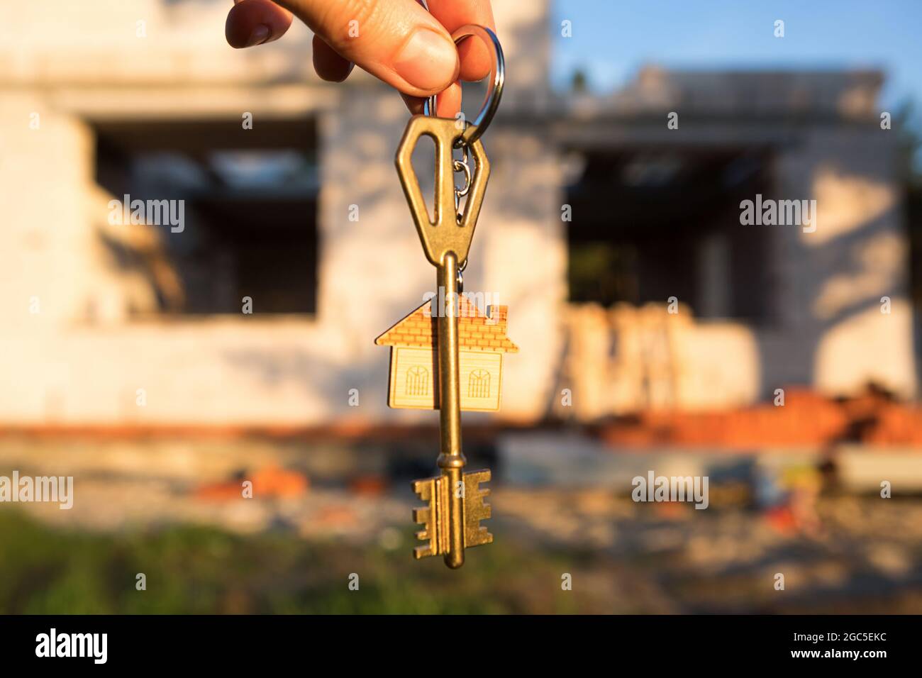 Hand with the key to the future house on the background of a ...
