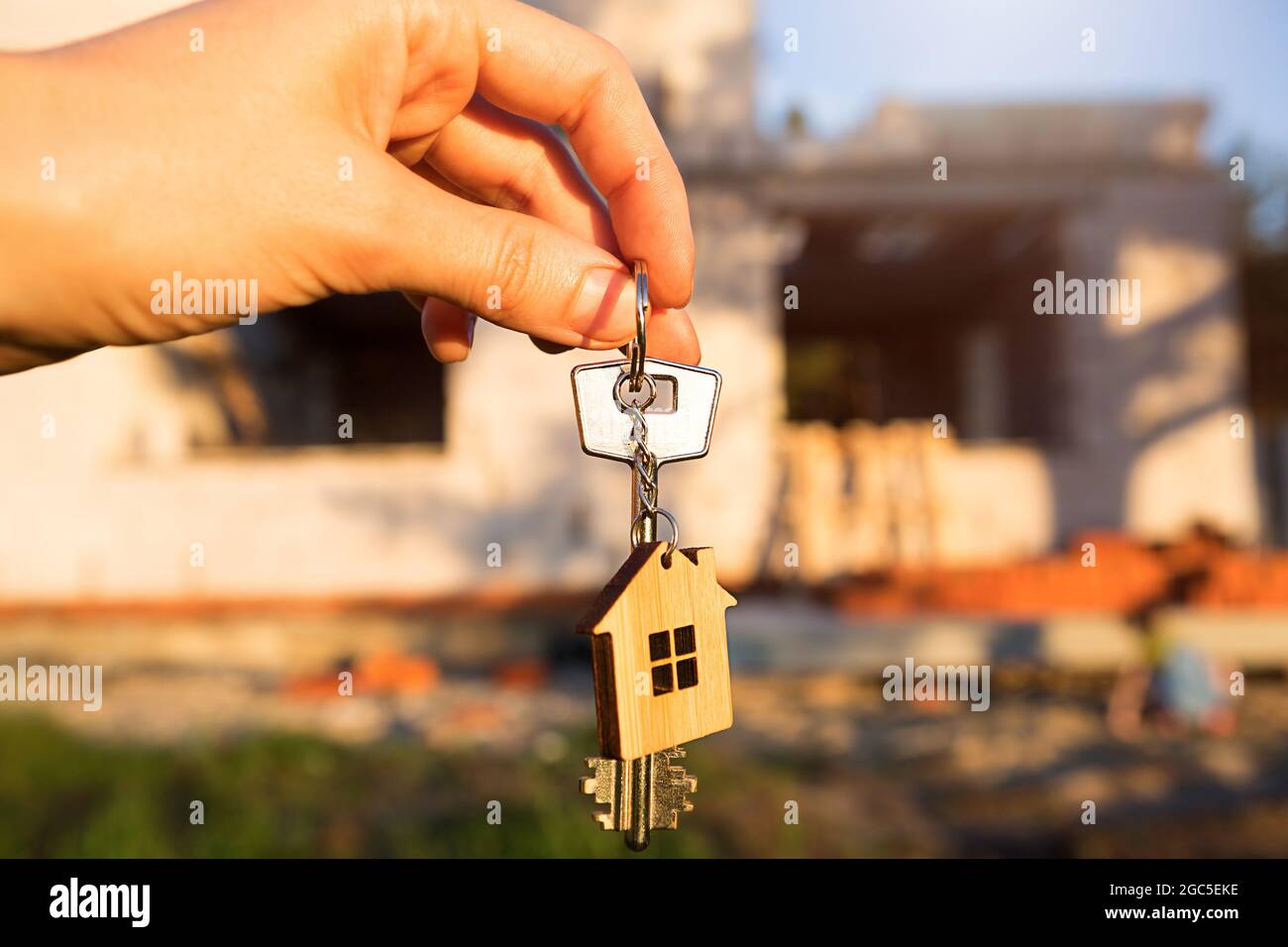 Hand with the key to the future house on the background of a ...