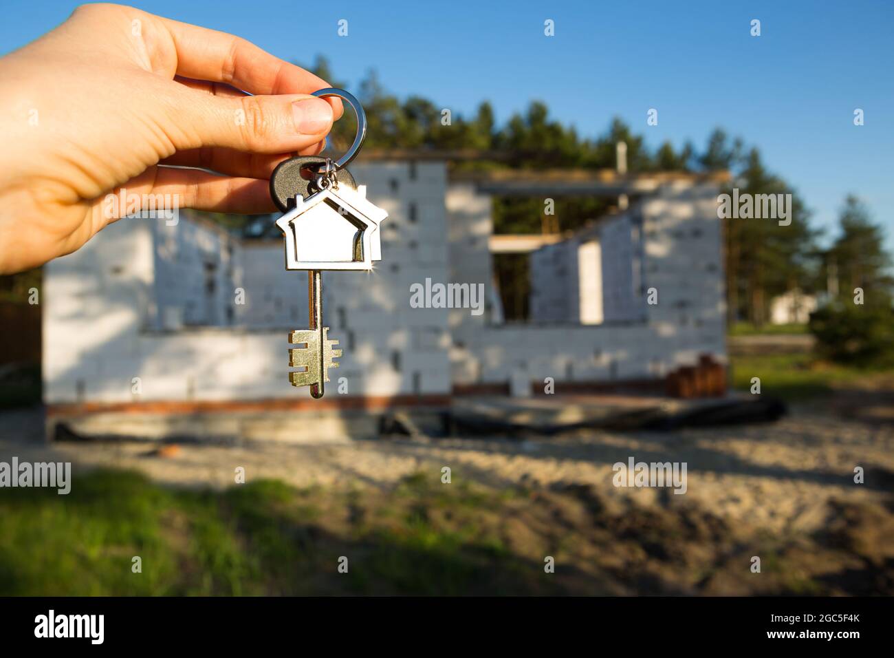 Hand with the key to the future house on the background of a ...