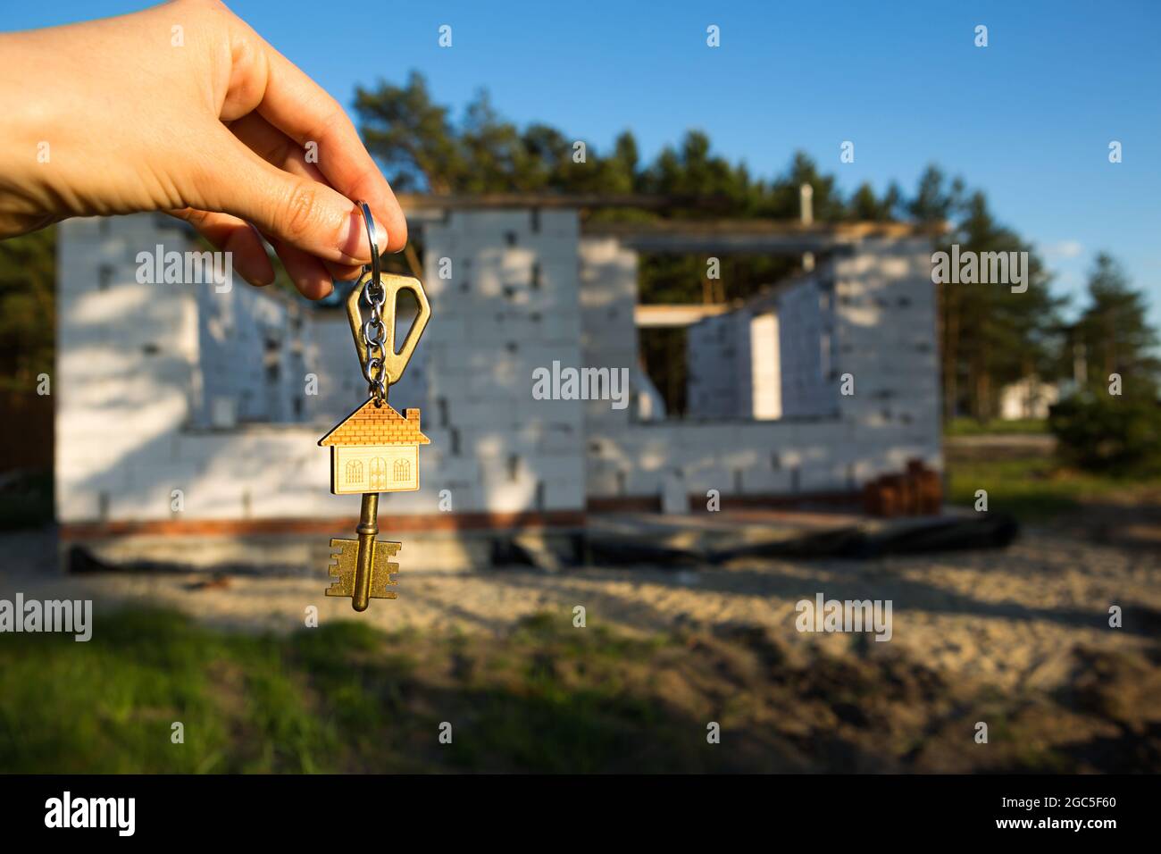 Hand with the key to the future house on the background of a ...