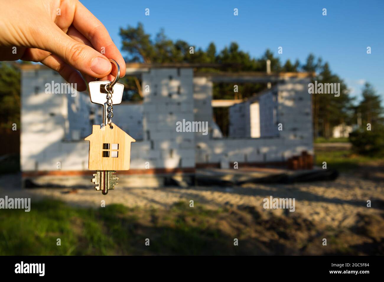 Hand with the key to the future house on the background of a ...