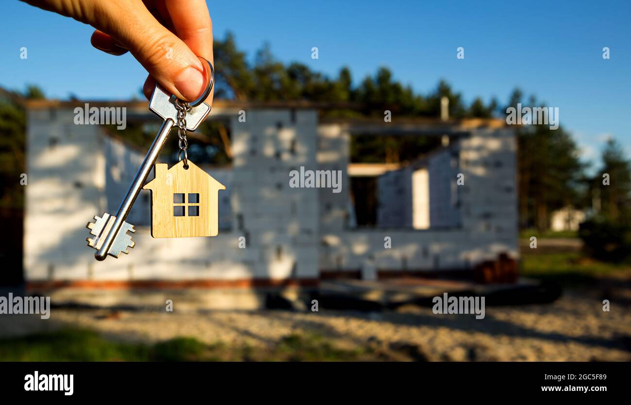 Hand with the key to the future house on the background of a ...
