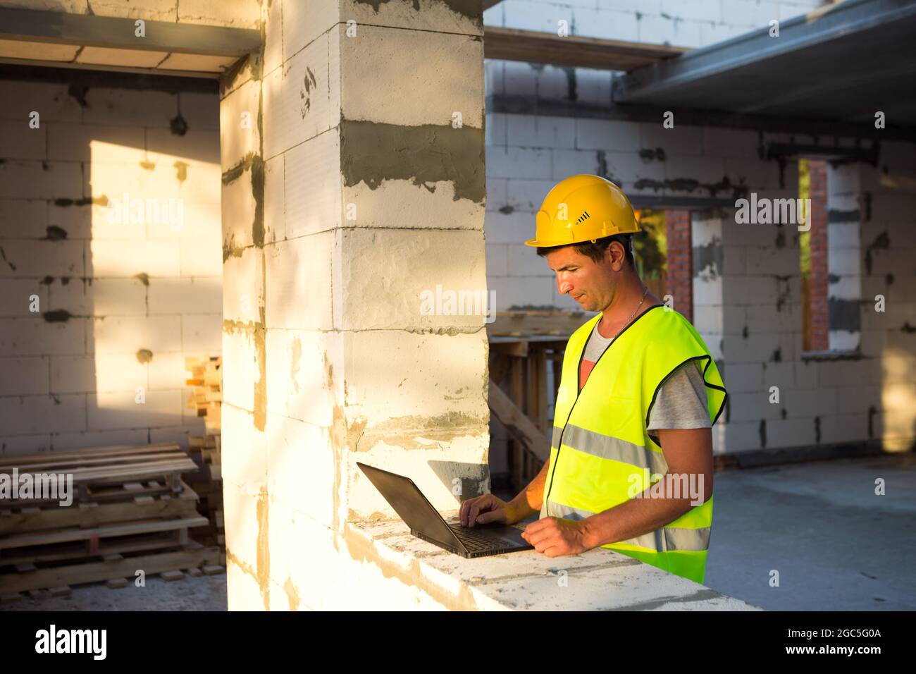 Construction engineer on the construction site of a house made of ...
