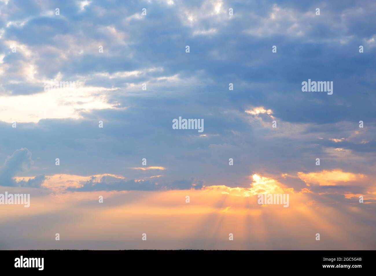Sunset through clouds flying heavenly hi-res stock photography and ...