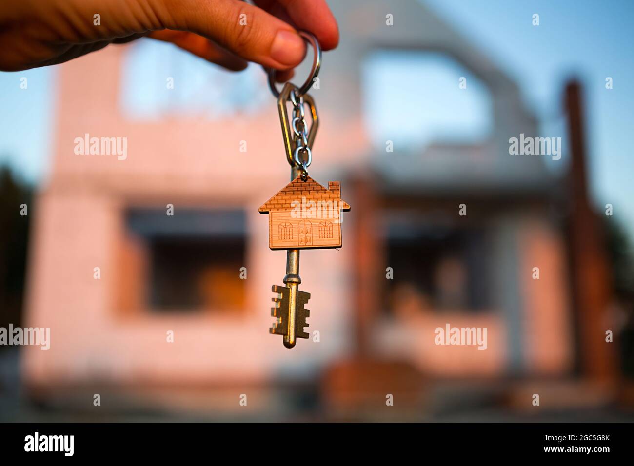 Hand with the key to the future house on the background of a ...