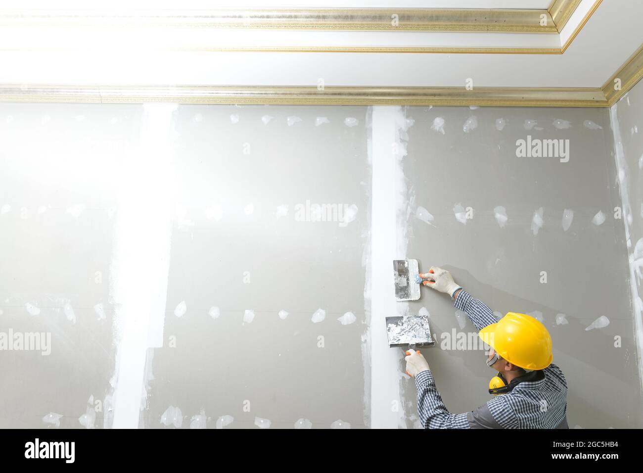 Putty plaster on the wall,Craftsman working with plaster gypsum ceiling ...