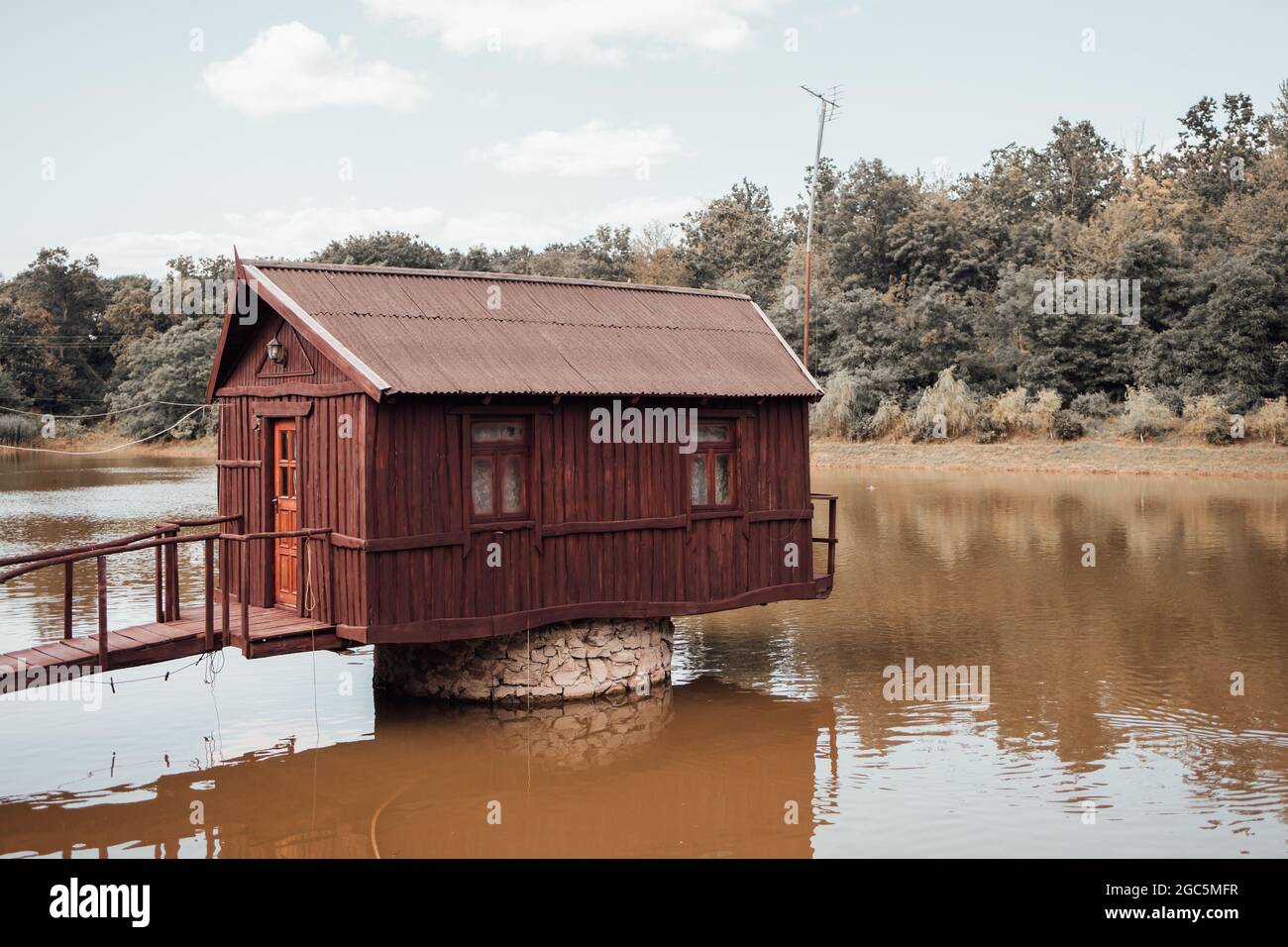 Old wooden house on a lake. Isolated building in nature. Arstistic ...