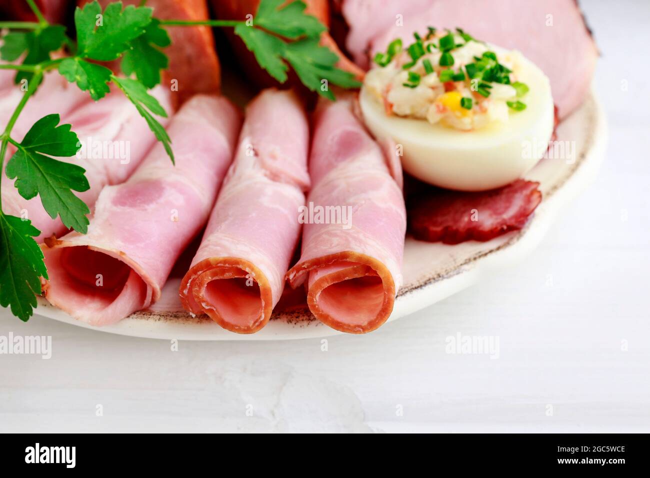 Plate with sliced ham and stuffed eggs. Festive breakfast Stock Photo ...