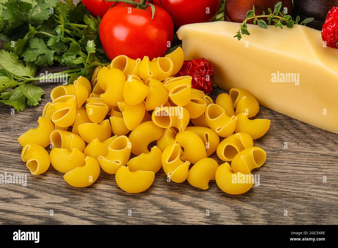 Italian pasta - raw pipe rigate served vegetables Stock Photo - Alamy