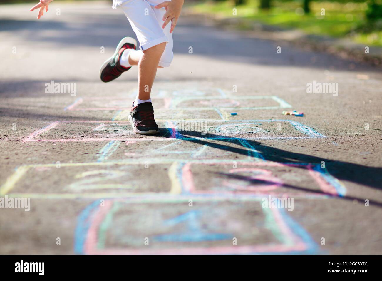 Kids play hopscotch in summer park. Healthy active outdoor game ...