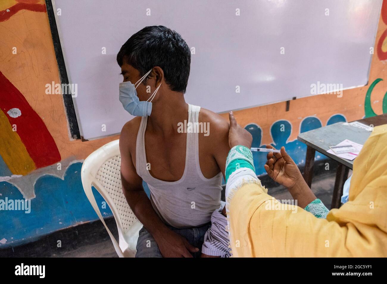 Dhaka, Bangladesh. 07th Aug, 2021. A healthcare worker injects Md Selim with Moderna Covid-19 ...