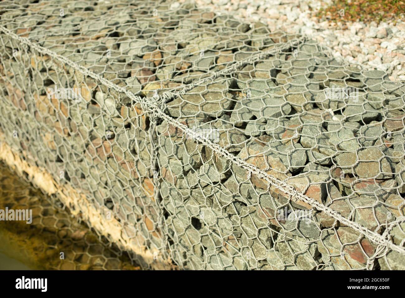 Coastline from flooding. Stone inside the net on the embankment. Stone ...