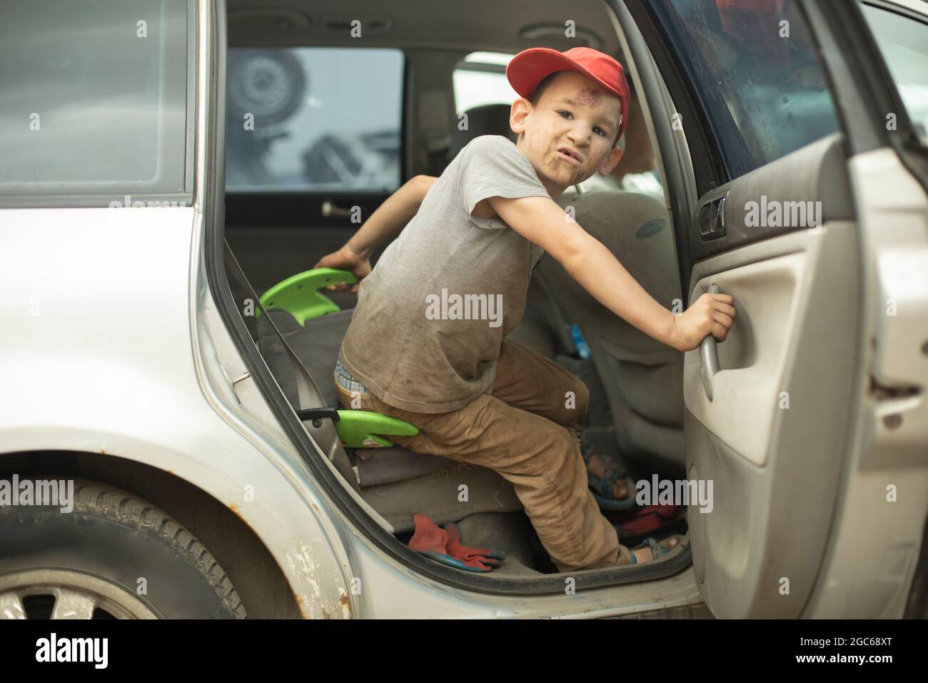 The child gets out of the car. The boy got into the vehicle. The child ...