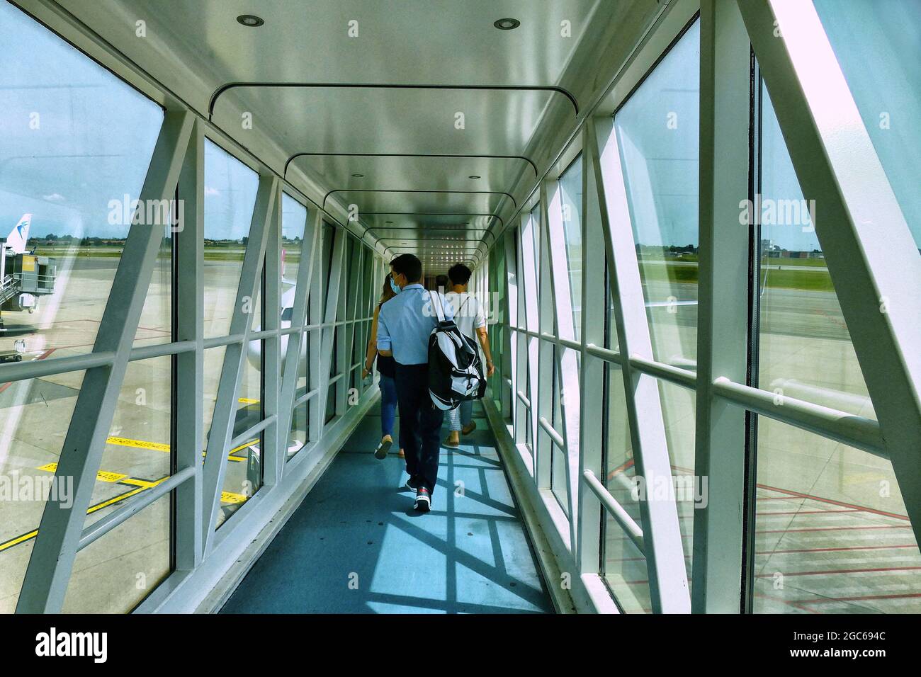 TURIN, ITALY - Jul 12, 2021: A traveler in the boarding corridor going ...