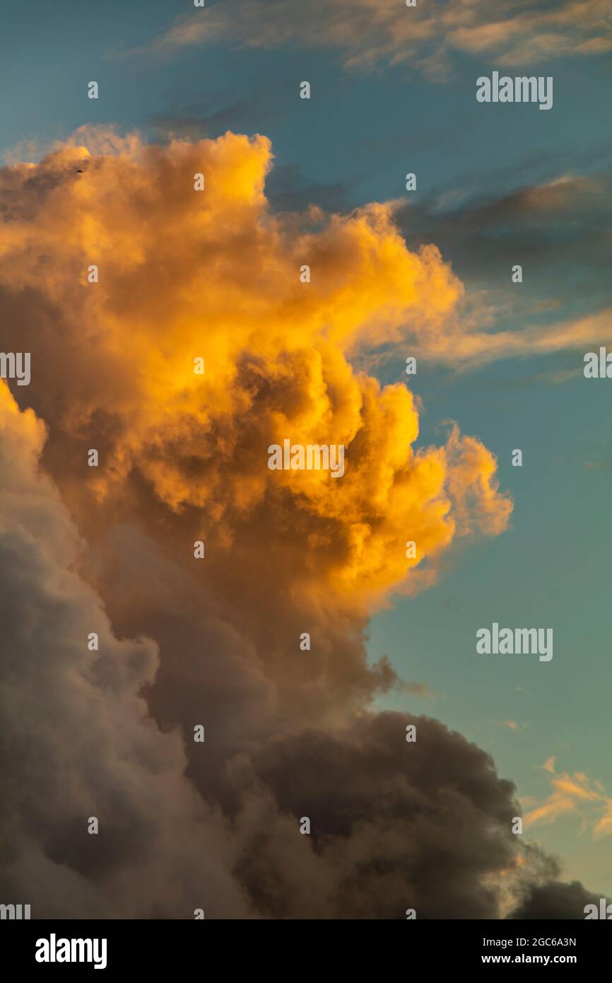 The setting sun light up some of the cloud cover Stock Photo - Alamy