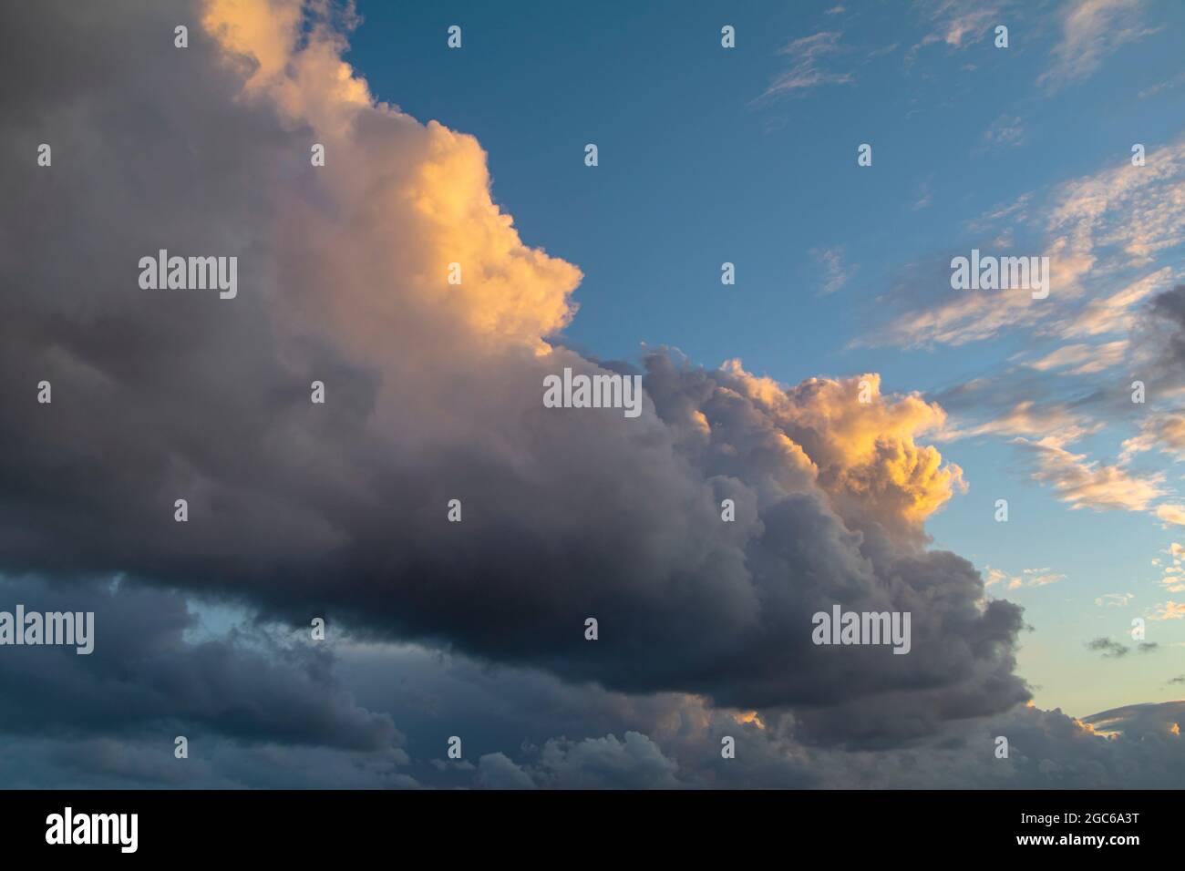 The setting sun light up some of the cloud cover Stock Photo - Alamy