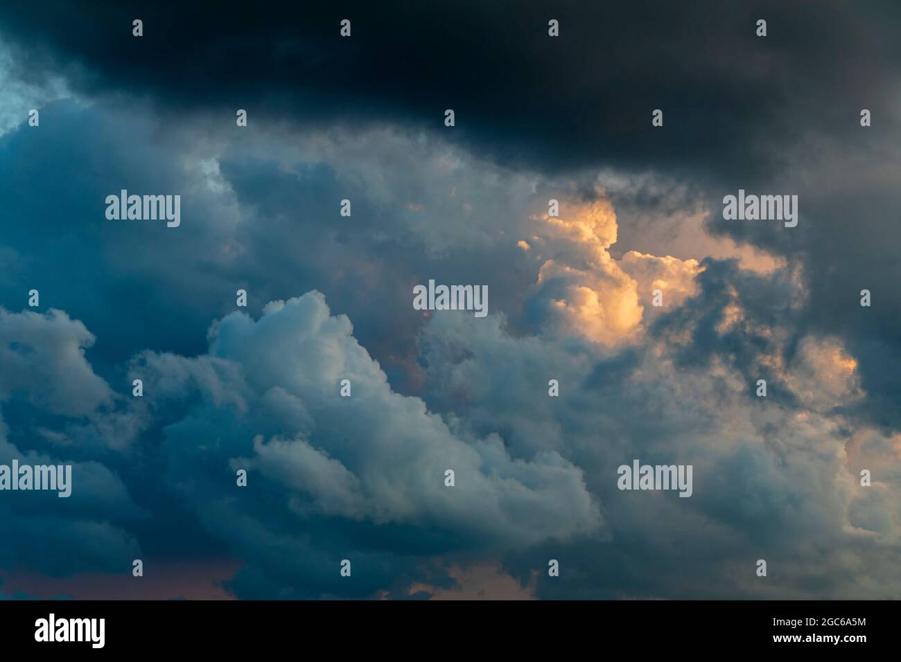 The setting sun light up some of the cloud cover Stock Photo - Alamy