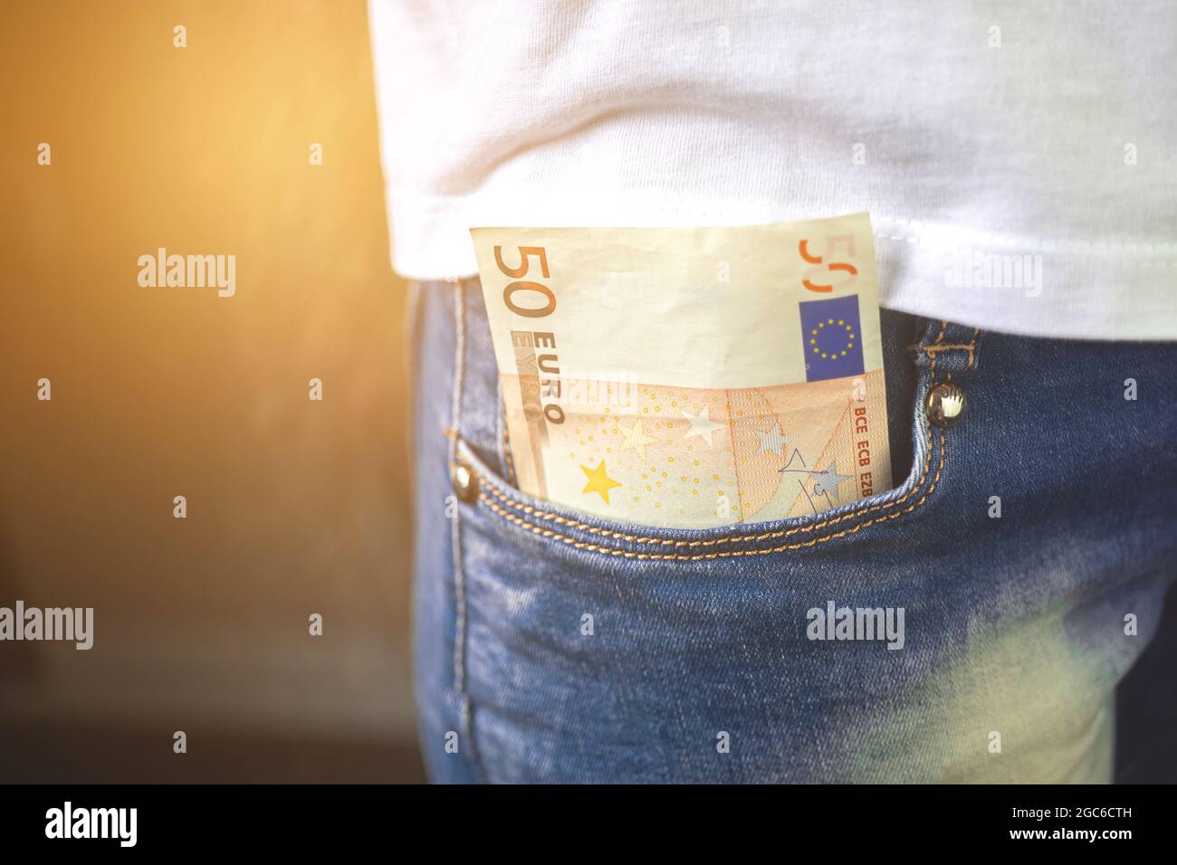 Euro money in pocket. Woman in denim jeans with euro currency in her ...