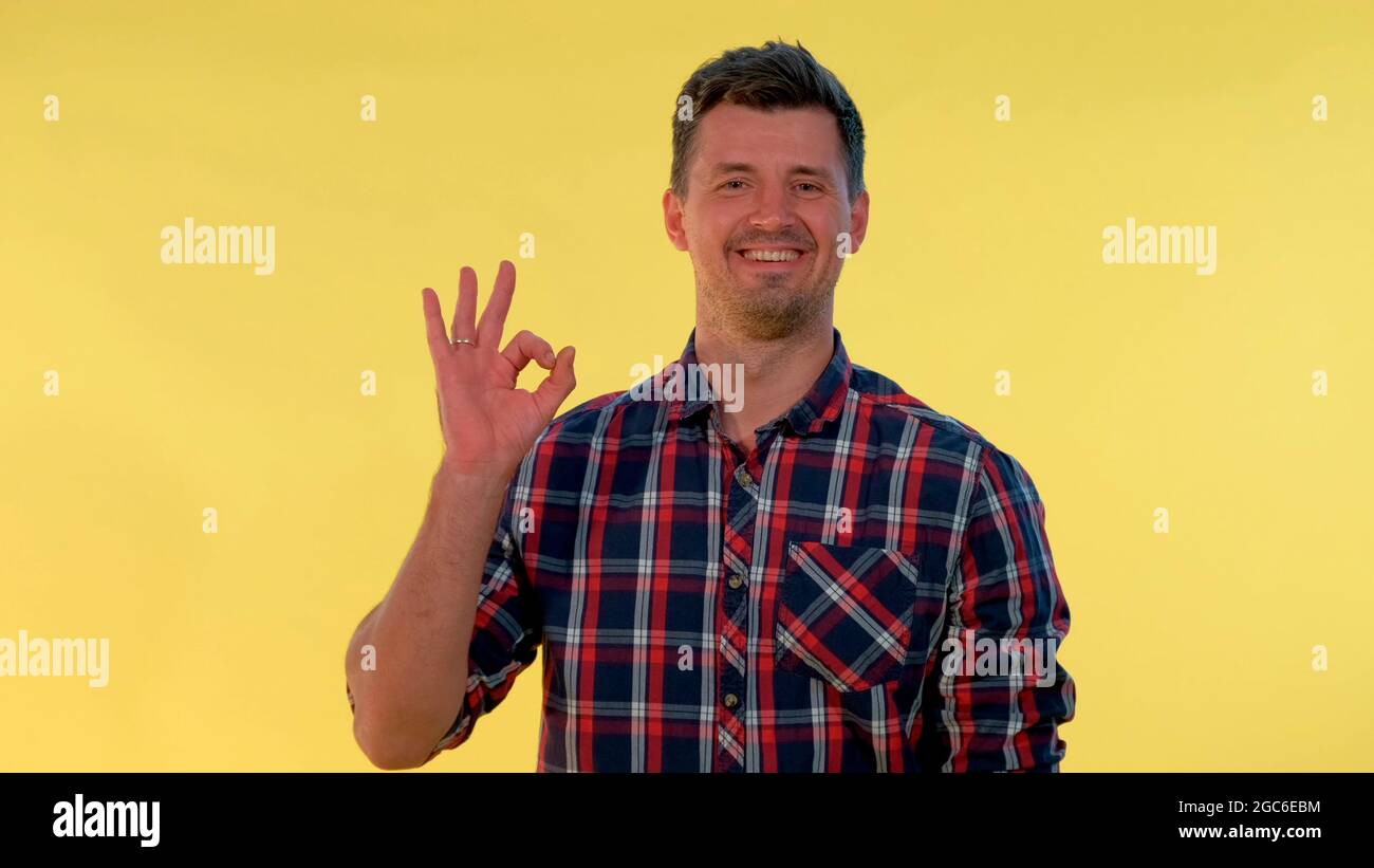 Attractive young man making 'okay' hand sign. He making hand gesture on ...