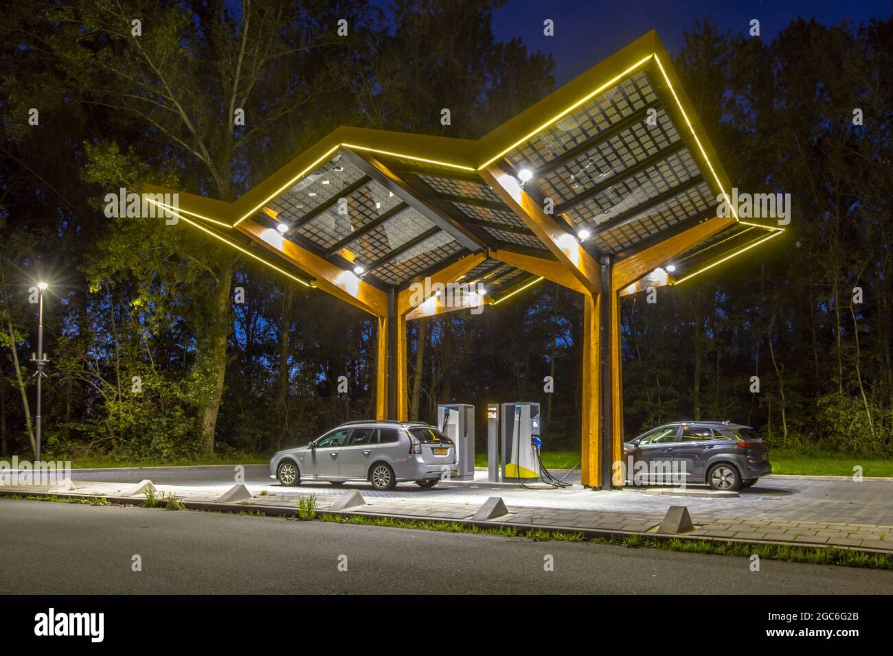 Electric cars charging at electricity filling station in the fast ...