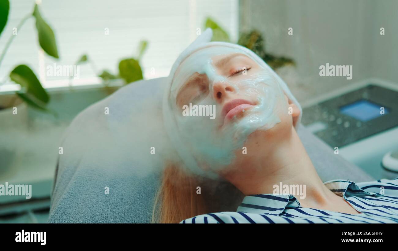 Medium close-up shot of professional facial skin care treatment with a ...