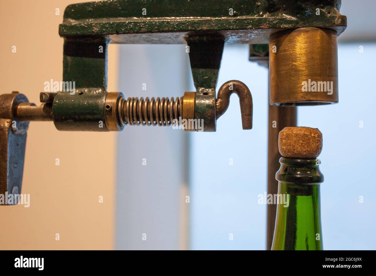 Old corking machine with cava bottle. Closeup Stock Photo - Alamy