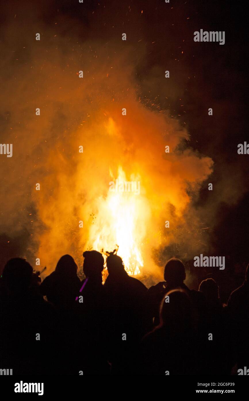 Audience watches a large bonfire, as part of a fireworks spectacular ...