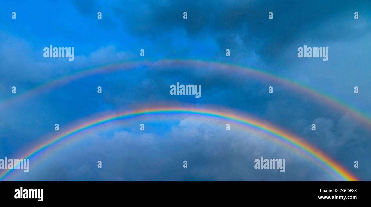 Double rainbow against stormy sky Stock Photo - Alamy