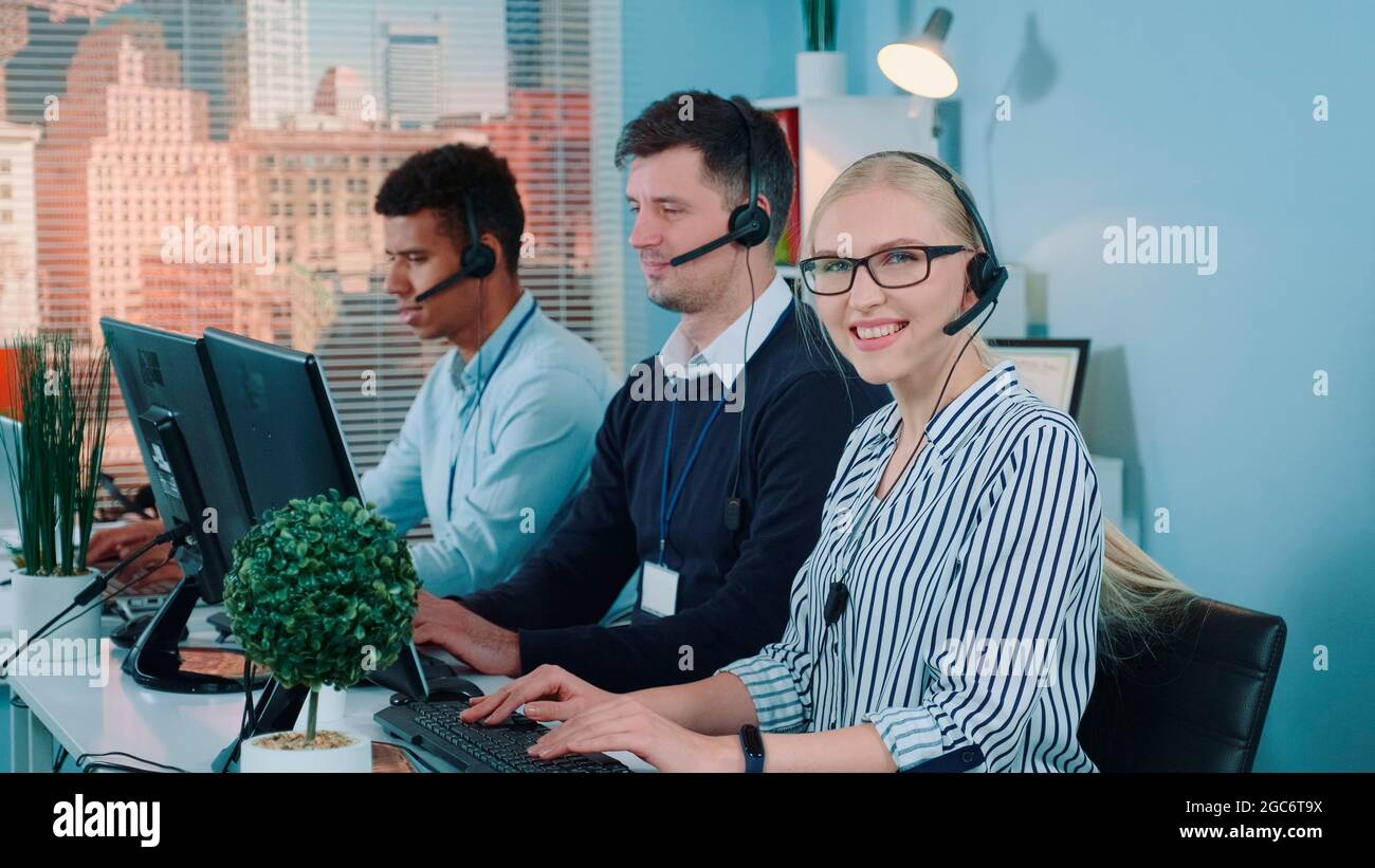 Beautiful female customer service working in busy call center by ...
