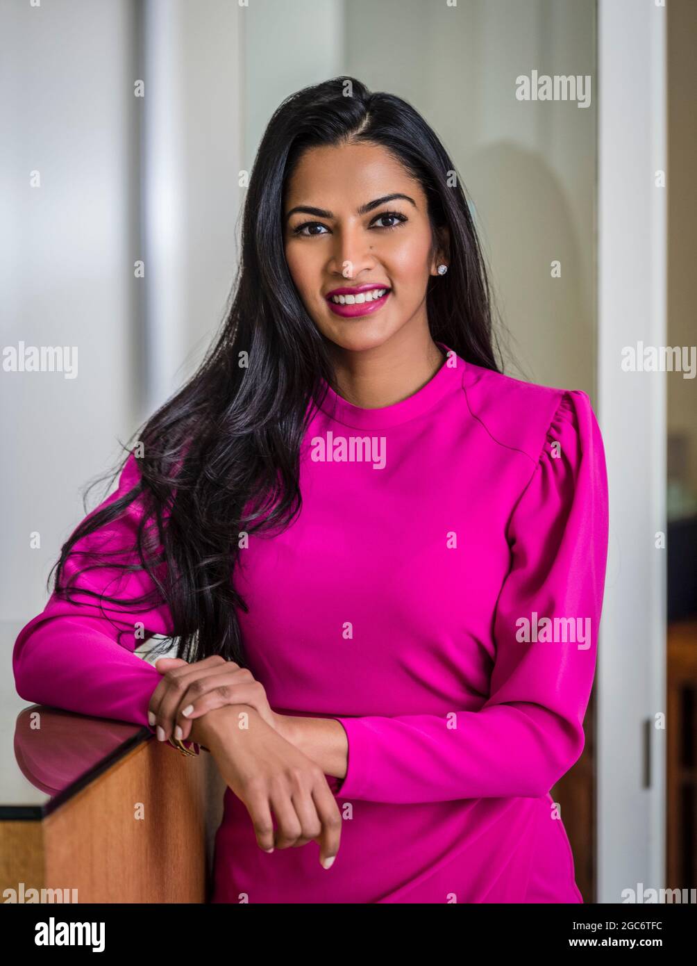 Portrait of beautiful woman at reception desk Stock Photo - Alamy