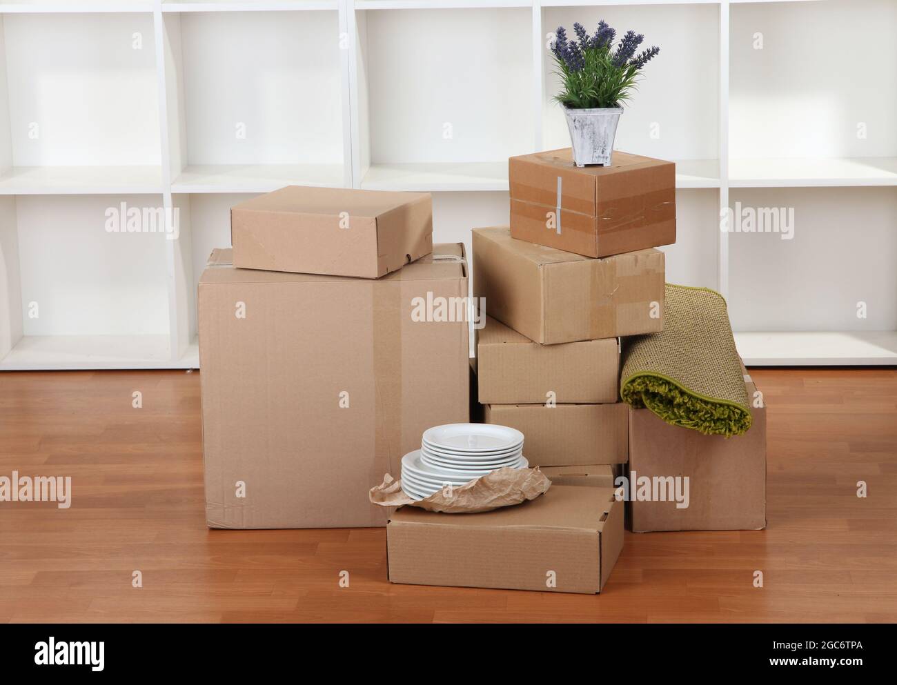 Moving boxes in empty room Stock Photo - Alamy