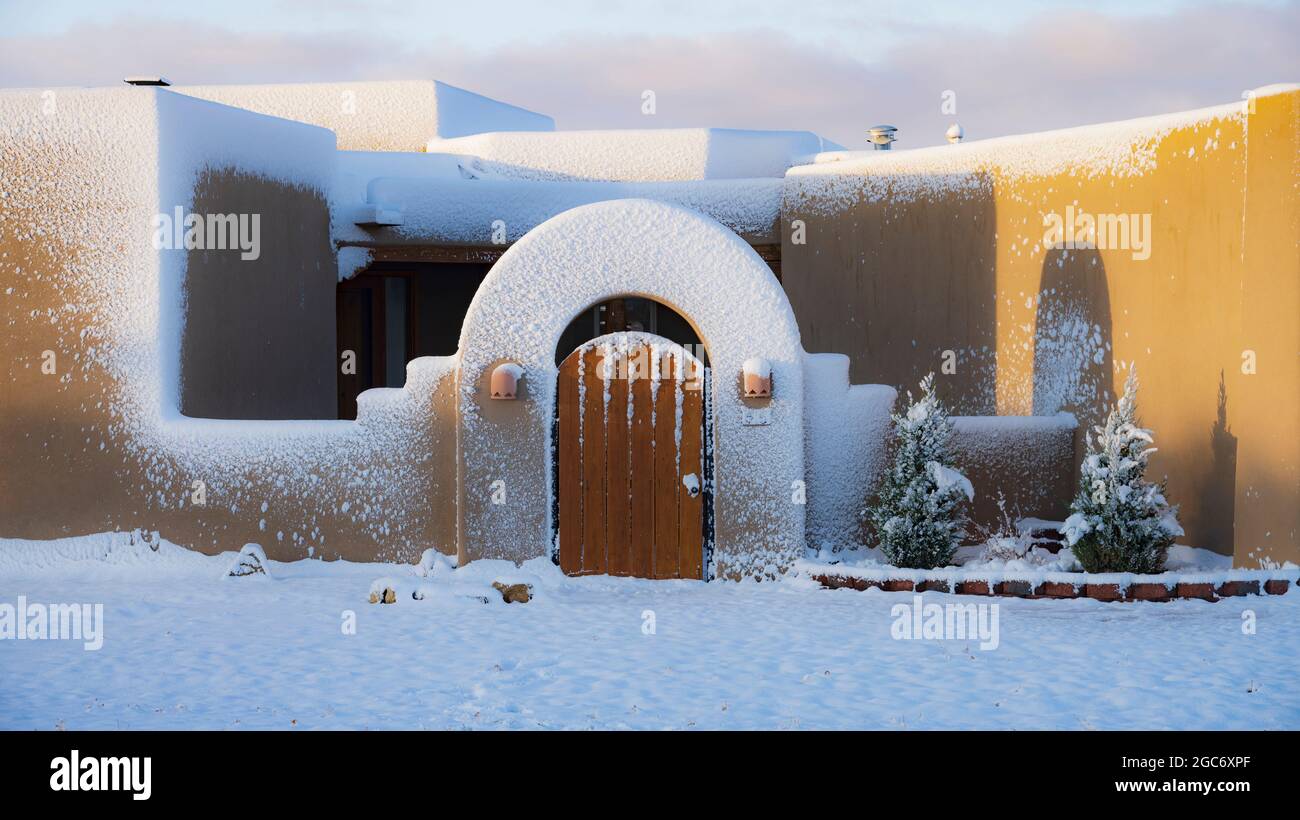 Usa, New Mexico, Santa Fe, Adobe style house covered with snow in ...
