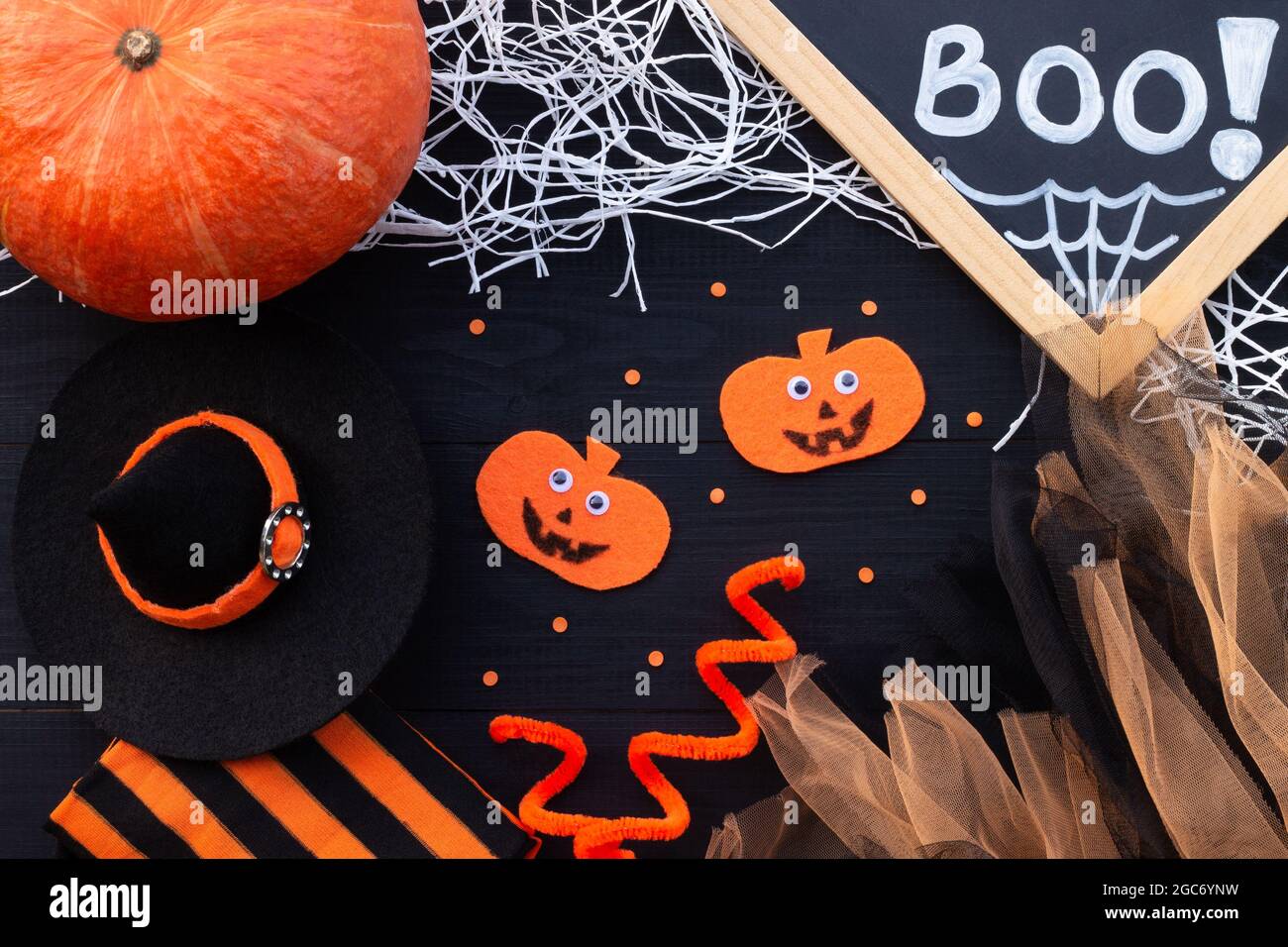 Orange and black Halloween flatlay. Chalk inscription BOO, pumpkins ...
