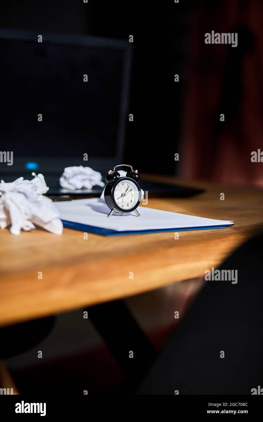 Modern workplace, wooden office desk in hardlight, sunligt with clock ...