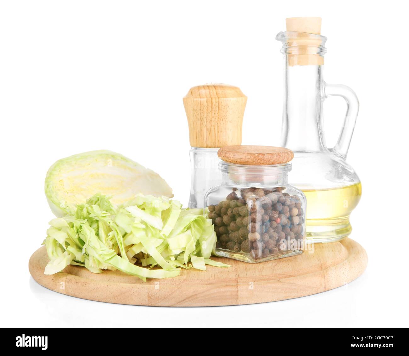 Green cabbage, oil, spices on cutting board, isolated on white Stock ...