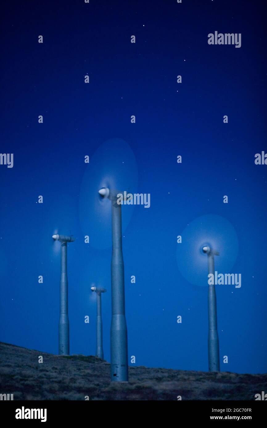 Wind turbines in landscape at night Stock Photo - Alamy