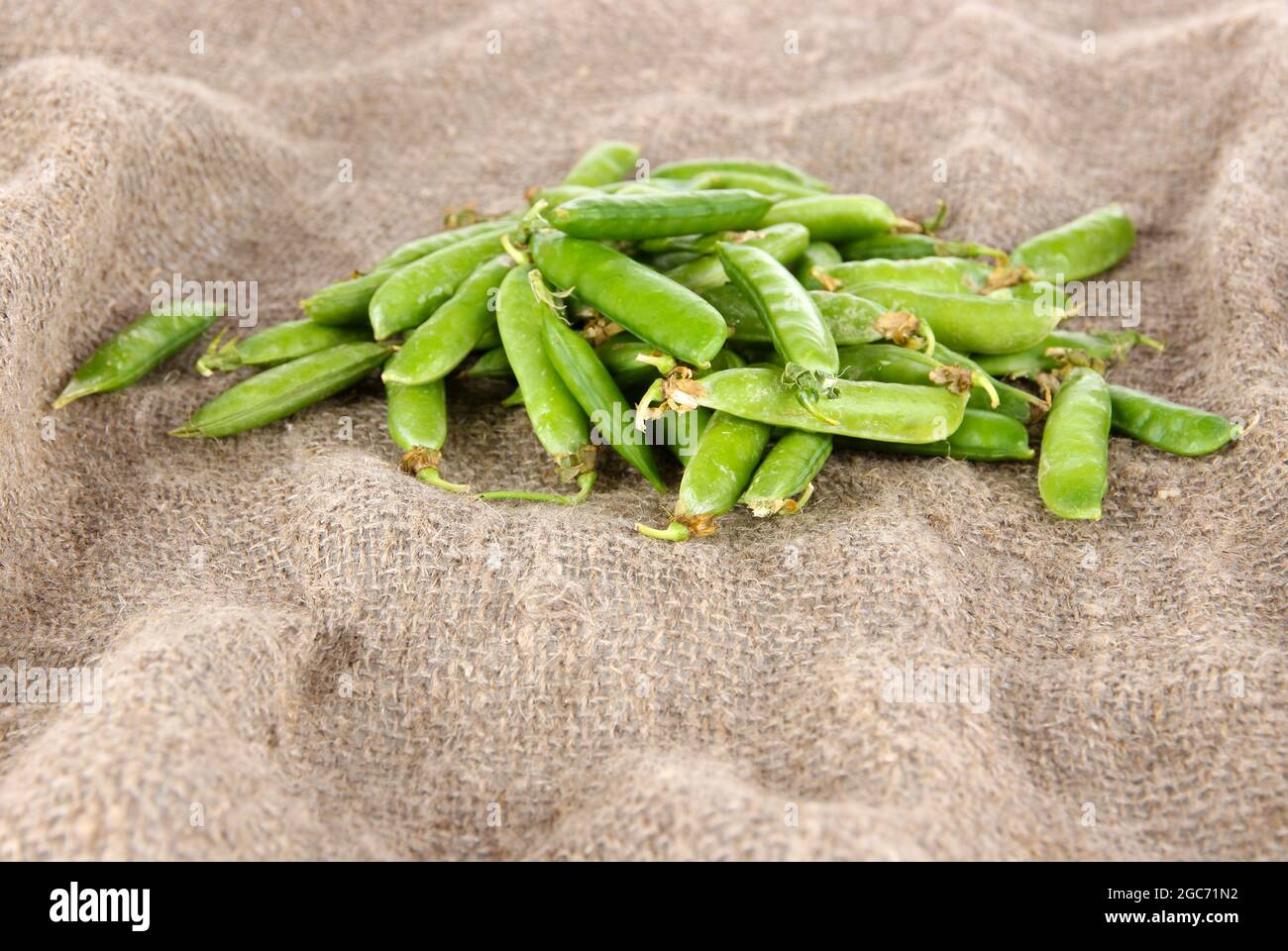 Green peas on bagging background Stock Photo - Alamy