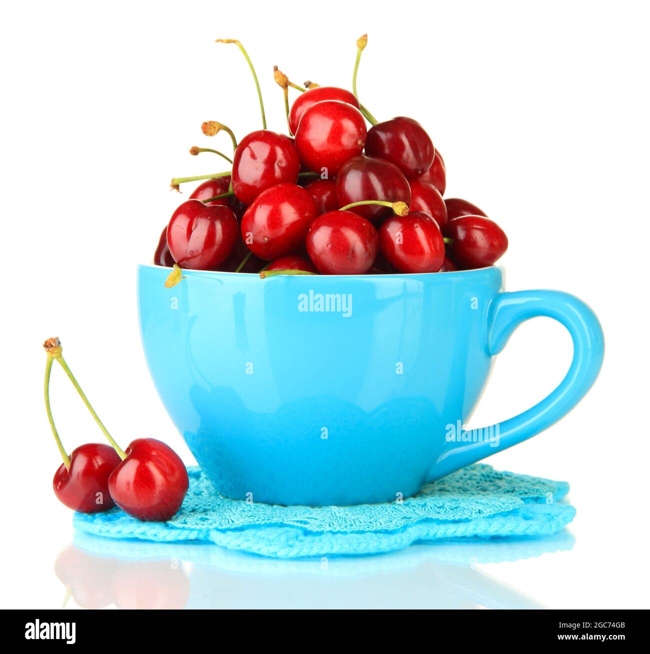 Ripe red cherry berries in cup isolated on white Stock Photo - Alamy