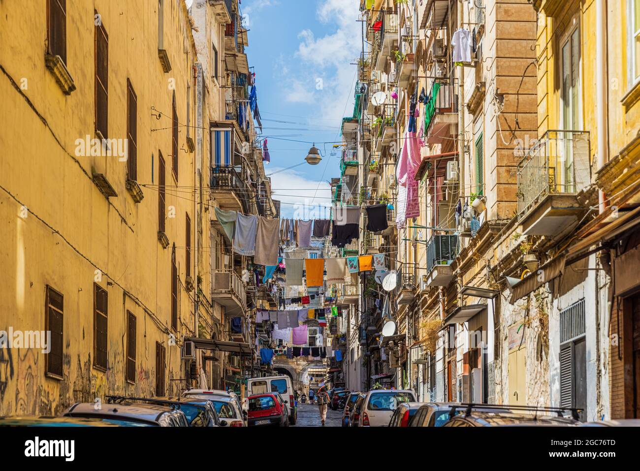 NAPLES, ITALY - JULY 18: Narrow street in Naples, clothes hanging in ...