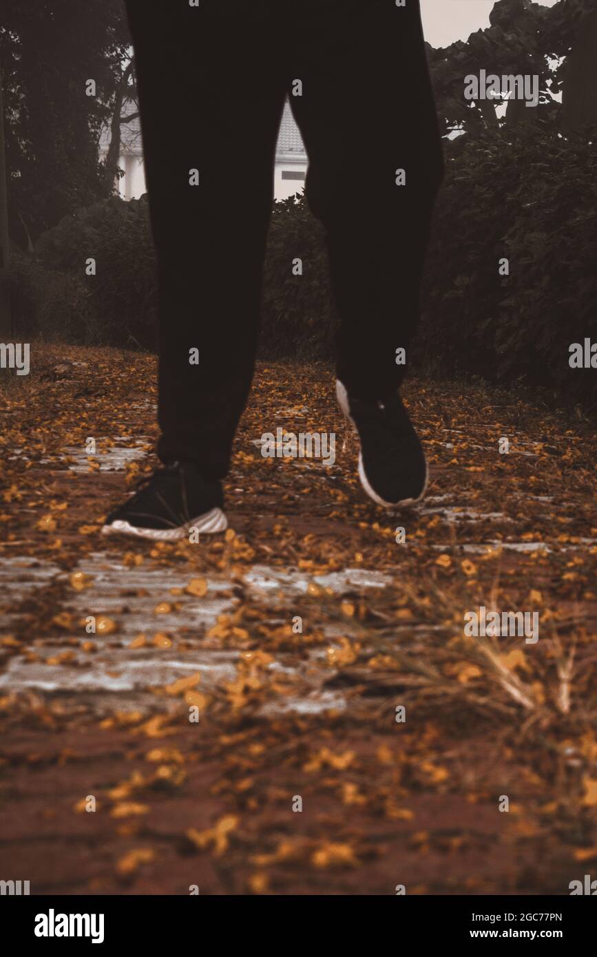 Man walking along the pathway Stock Photo - Alamy